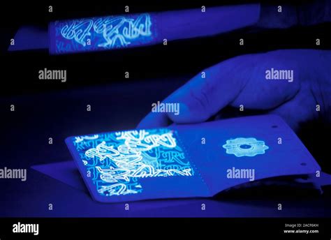 Forensic Forgery Investigation Security Holograms On A Passport Being Examined Under
