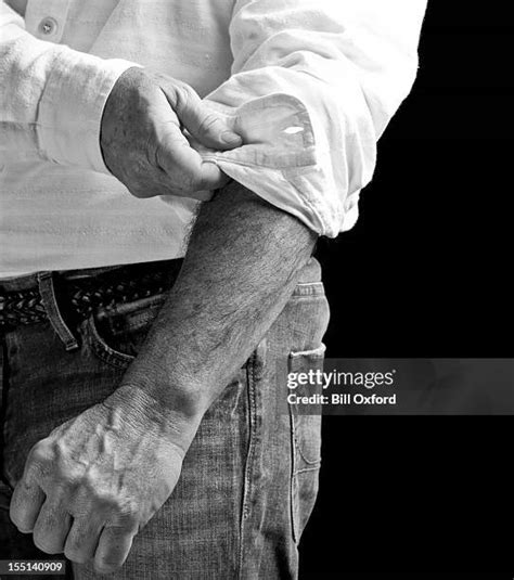 Man Rolling Up Sleeves Photos And Premium High Res Pictures Getty Images