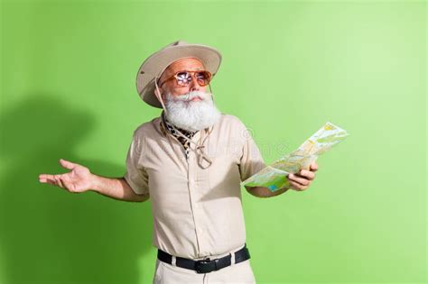 Photo Of Puzzled Old Man Adventurer Hold Map Lost In Travel Trip Wear Safari Suit Isolated Green