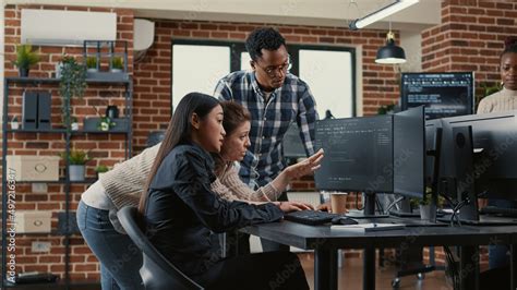 Mixed Team Of Software Engineers Brainstorming Ideas For New Cloud