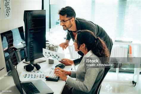 Hispanic Programmers Collaborating On Software Development In A Modern
