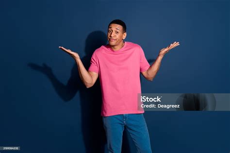 Photo Of Young Funny Guy In Pink Stylish T Shirt Confused Shrug