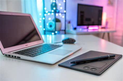 Stylish Workspace With Laptop Graphic Tablet And Vibrant Lighting Stock Illustration