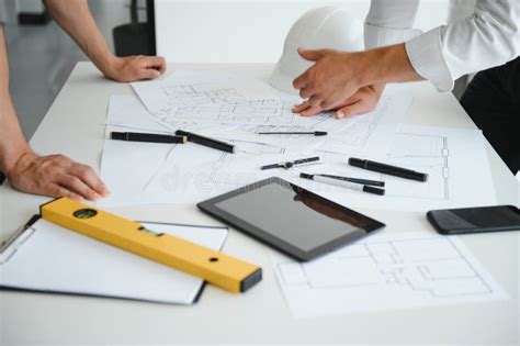 Team Of Architects People In Group On Construciton Site Check Documents