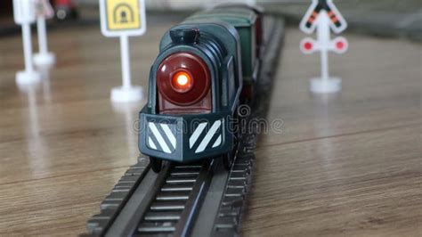a model train running on a track featuring signals along with various