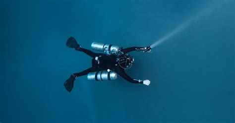 Instructor Surfaces As A Sidemount Diver Undeterred By Obstacles