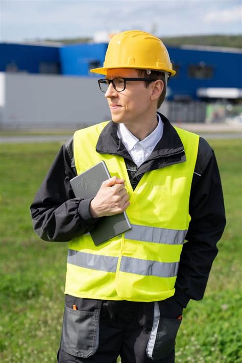 Engineer With Digital Tablet On A Background Of Power Line Tower Stock