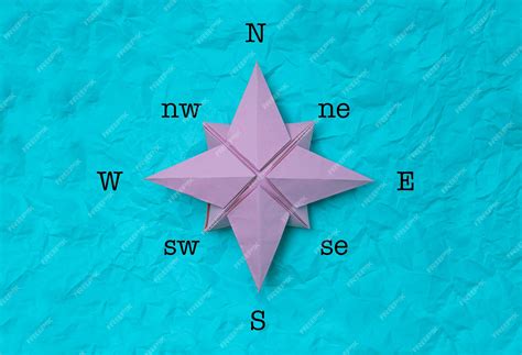 Premium Photo Top View Of Origami Compass Rose On Crunched Blue Background
