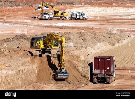 A Heavy Duty Excavator Loads A Container Truck With Hazardous Uranium