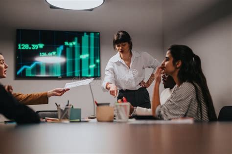 Team Collaborating In Office With Digital Chart Displayed On Screen Stock Image Image Of