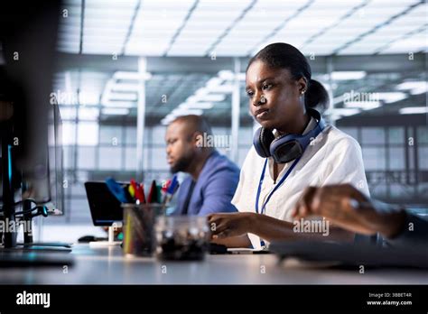African American Engineer Next To Coworkers In Server Farm Checking Recovery Plan Monitoring