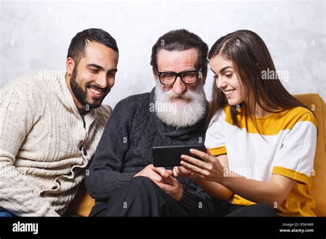 Brunette Bearded Son And Brunette Long Haired Daughter Showing Photos