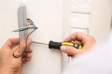 Premium Photo Male Technician Installing Security Alarm System