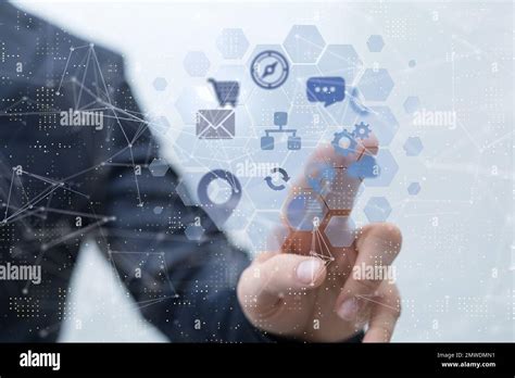 A Businessmans Hand Tapping A Digital Floating Render Of A Network Of Connected Business Icons