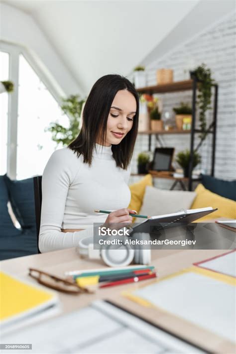 Modern Female Student Studying And Doing A Checklist For Herself Stock
