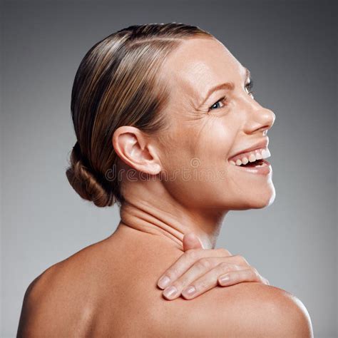 Beautiful Mature Woman Posing In Studio Against A Grey Background Stock