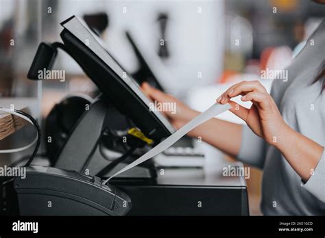 saleswoman printing invoice or receipt for a customer in the shopping