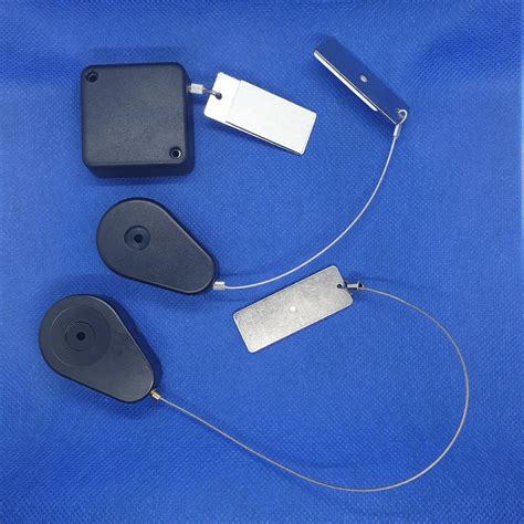 Security Tether With Retractable Cable And Adhesive Pul — Hang And Display