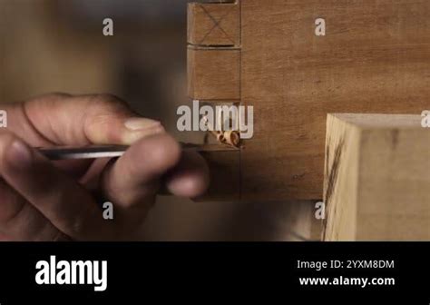 Close Up Of A Carpenter Chiseling A Mortise In Wood For A Multiple Mortise And Tenon Joint This