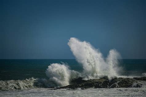 A Large Wave Crashes Into The Shore Of The Ocean Photo Free Nature