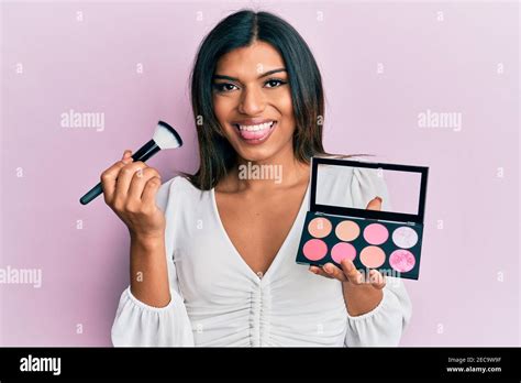 Young Latin Transsexual Transgender Woman Holding Makeup Brush And