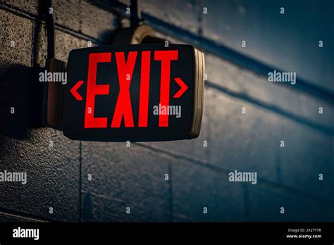 Glowing Exit Sign By Night On Wall Stock Photo Alamy