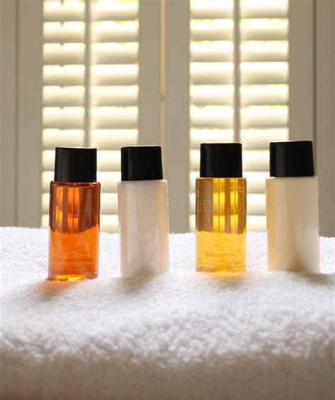 Hotel Bathroom Mini Bottles Of Shampoo And Conditioner On White Towel
