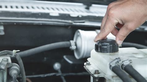 Premium Photo Hand Checking Level Of Coolant Car Engine