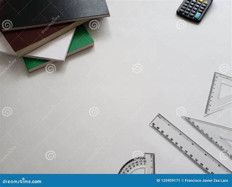 stacked books set of geometry objects and calculator stock image