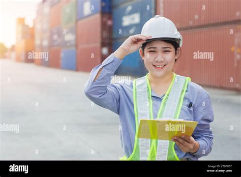 Asian Woman Happy Dock Worker Control Loading Containers Cargo At Shipyard Marine And Carrier