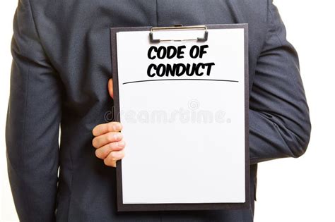 Businessman Holding Clipboard With Heading Code Of Conduct Stock Photo Image Of Fairness