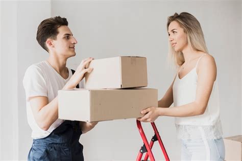 Free Photo Front View Couple Holding Moving Boxes