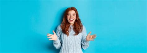 Free Photo Excited Redhead Woman Shaking Hands Explaining Big News Staring At Camera Amazed