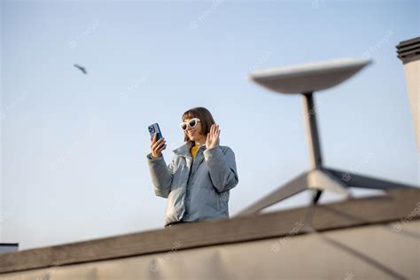 Premium Photo Woman Uses Satellite Internet Connection On Roof Of A House