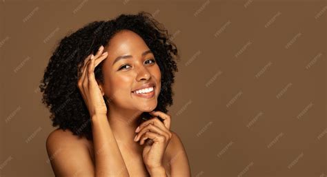 Premium Photo Cheerful Young Black Woman Posing Topless On Brown