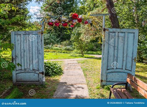 A Creative Garden Entrance Made Of Two Old Decorative Doors Forming An