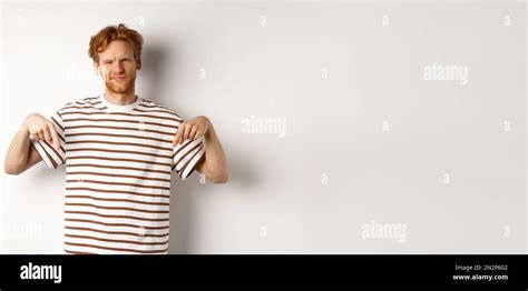 Disappointed Redhead Man Shaking Head Displeased Showing Something Bad Pointing Fingers Down