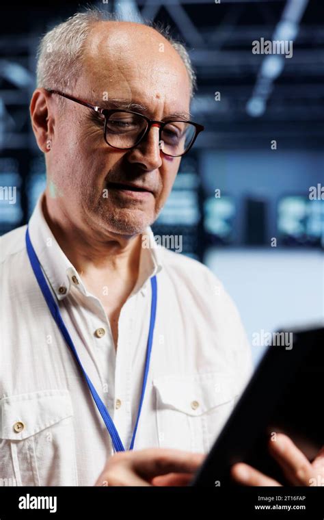 Octogenarian Engineer In Crypto Mining Farm With Specialized Server Racks Using Blockchain