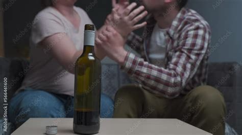 Man And Woman Couple Alcoholic Fight At Home On Couch Bottle Of