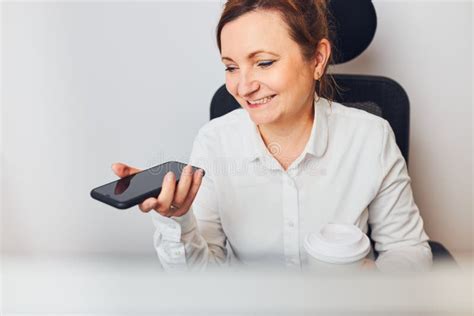 Businesswoman Talking On Mobile Phone Using Speaker Mode Woman