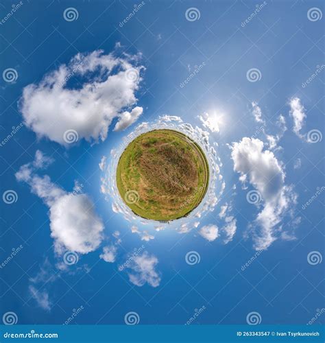 Green Tiny Planet In Blue Sky With Beautiful Clouds With Transformation