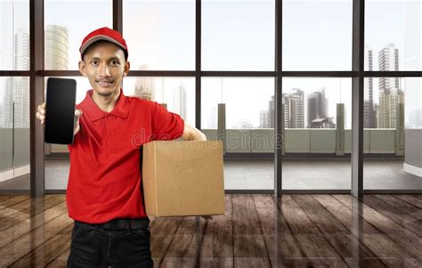 Parcel Delivery Man With A Hat Showing His Mobile Phone Screen While