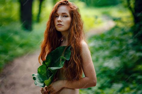 Premium Photo Ginger Beautiful Woman Holding A Big Leave Over Her