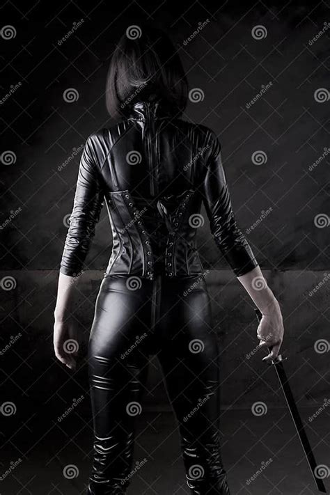 Killer Female Assassin With Swords Wearing Black Leather Stock Image