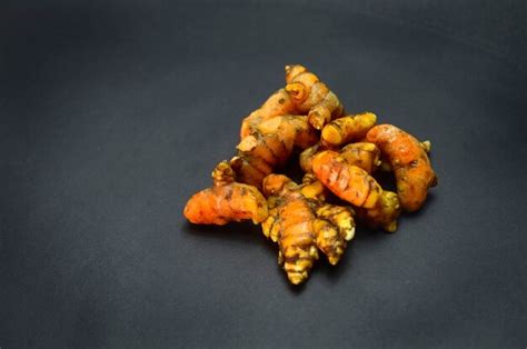 Premium Photo Group Of Fresh Tumeric Spice On Black Background