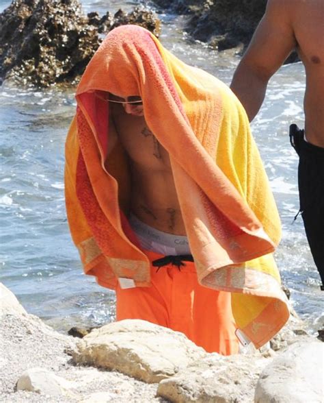 Embarrassed Justin Bieber Hides His Head— And Bares His Butt— As He