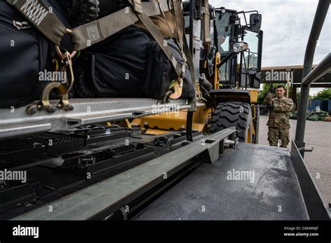 Airmen Assigned To The 32nd Aerial Port Squadron Load A Pallet Of Cargo