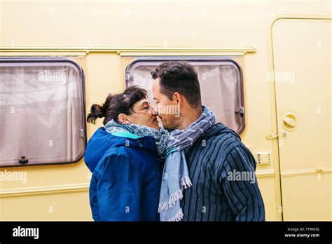 Couple Standing While Kissing Outdoors Stock Photo Alamy