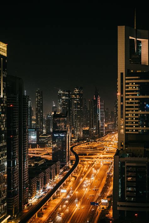 Vibrant Nightscape Of Illuminated Urban Roads Wallpaper Background