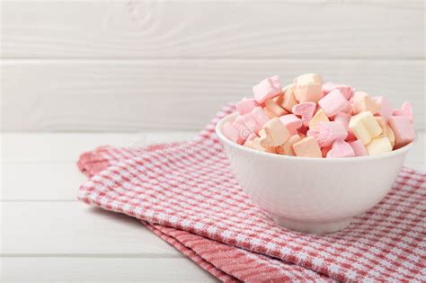 Many Different Marshmallows In Bowls And Jars On Textured Wood Stock